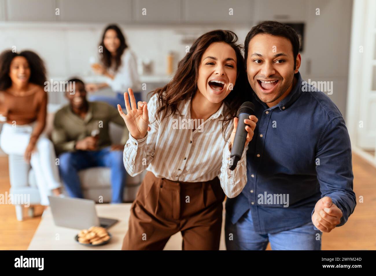 Couple singing enthusiastically into a mic at home Stock Photo - Alamy