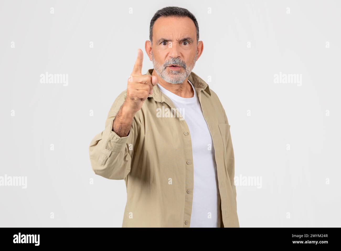 Senior man scolding with finger up on white background Stock Photo - Alamy
