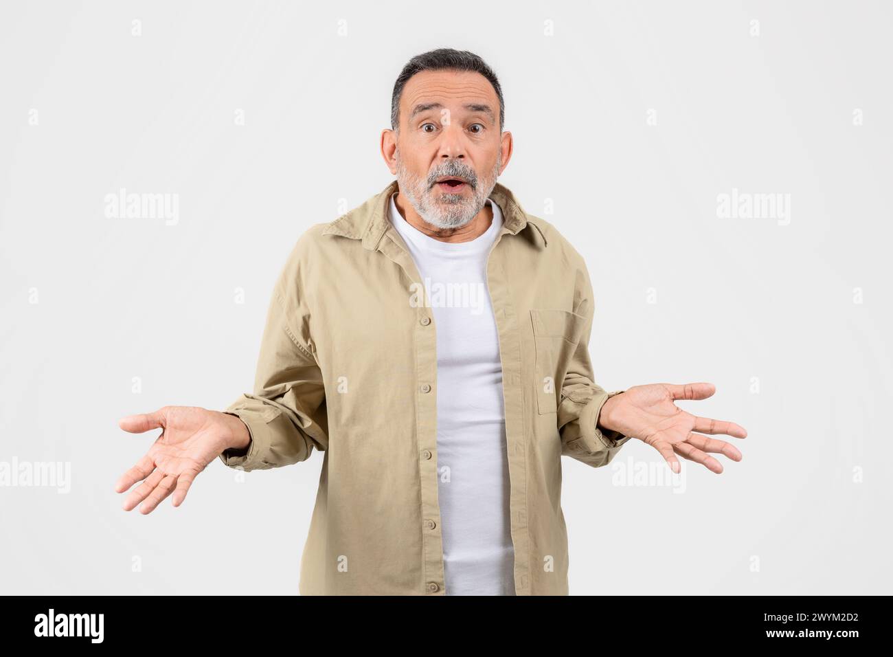 Surprised senior man shrugging shoulders on background Stock Photo - Alamy