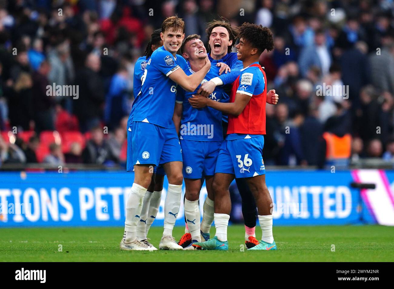 Peterborough United's Harrison Burrows (centre) and team-mates ...