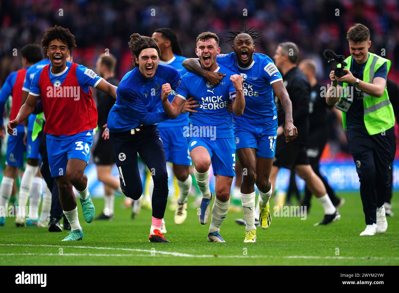 Peterborough United's Harrison Burrows (centre) and team-mates ...
