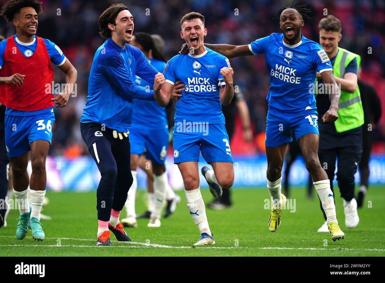 Peterborough United's Harrison Burrows (centre) and team-mates ...
