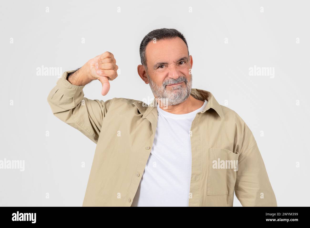Senior man showing thumbs down in disapproval Stock Photo - Alamy