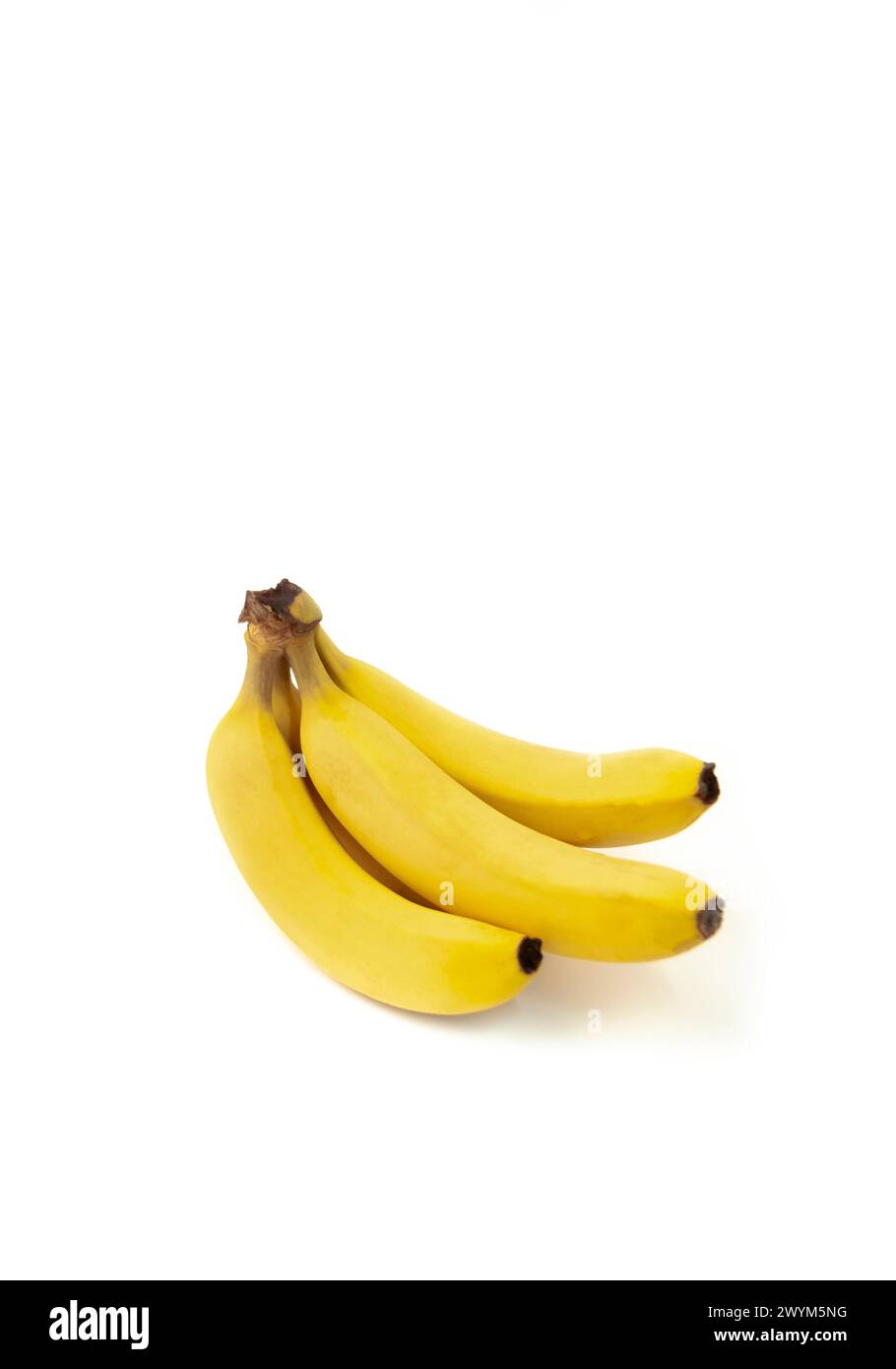 Three yellow bananas are sitting on a white background. The bananas are ...