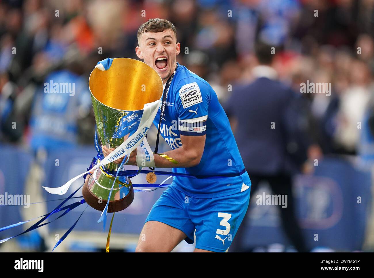 Peterborough United's Harrison Burrows celebrates with the trophy after ...