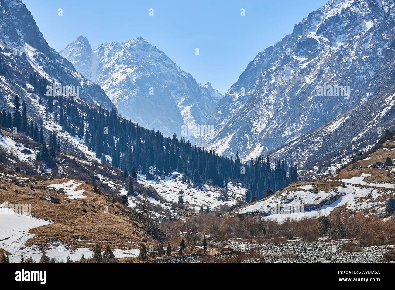 Spring landscape of a mountain valley. Snow-capped high mountains in ...