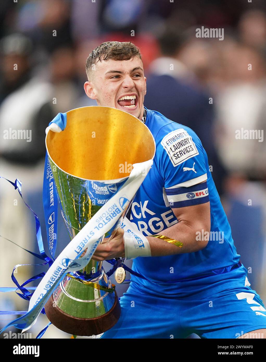 Peterborough United's Harrison Burrows celebrates with the trophy after ...