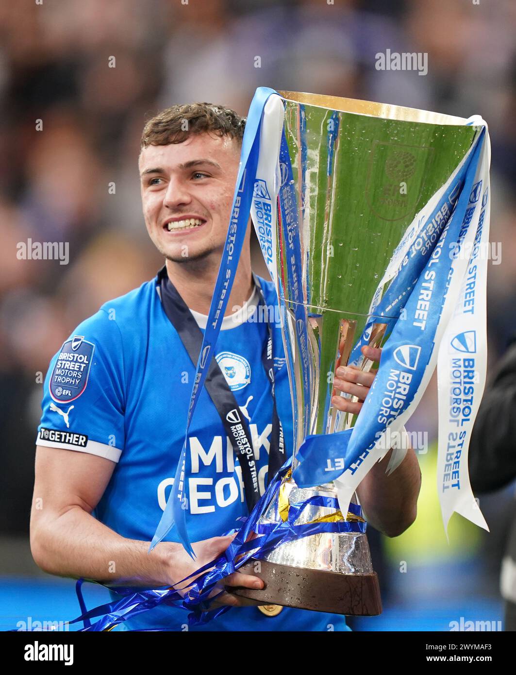 Peterborough United's Harrison Burrows celebrates with the trophy after ...