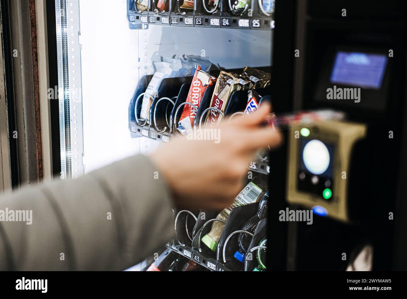 Person Using a Vending Machine for Snacks Stock Photo - Alamy