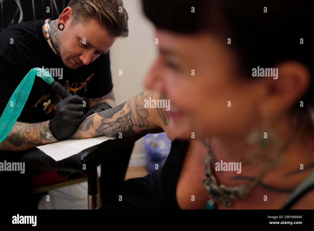 Lalitpur, Nepal. 05th Apr, 2024. A woman gets inked on her hand by a ...