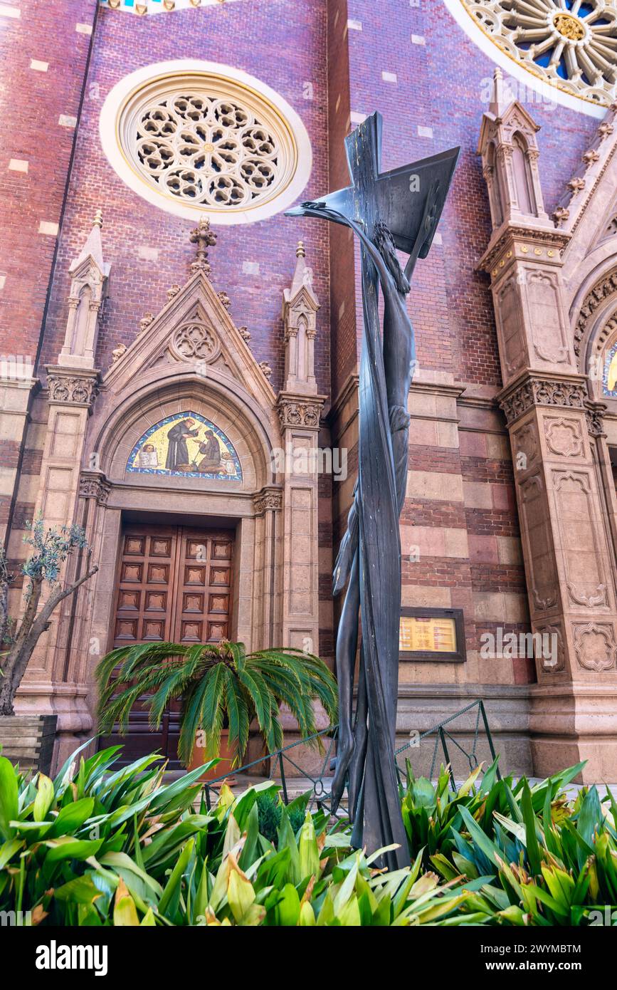 Modern art statue of Jesus Christ in front of St. Anthony of Padua ...