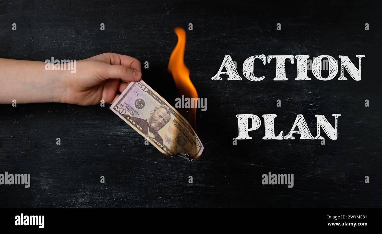 A hand holding a burnt dollar bill with the words Action Plan written ...