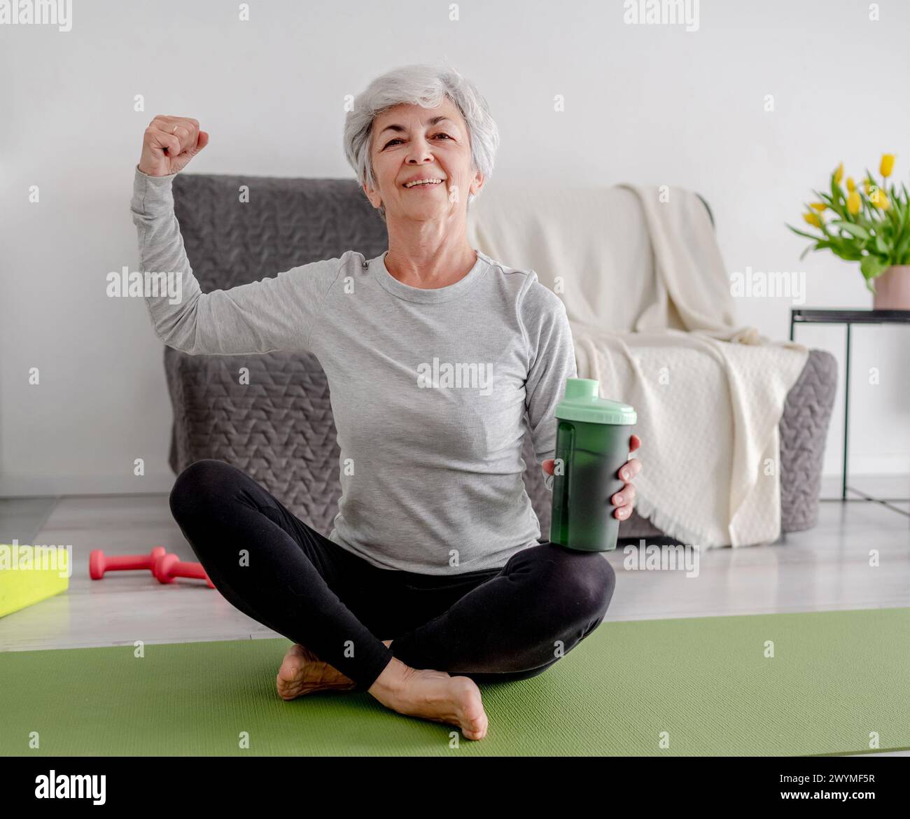 Mature woman flexing biceps hi-res stock photography and images - Alamy