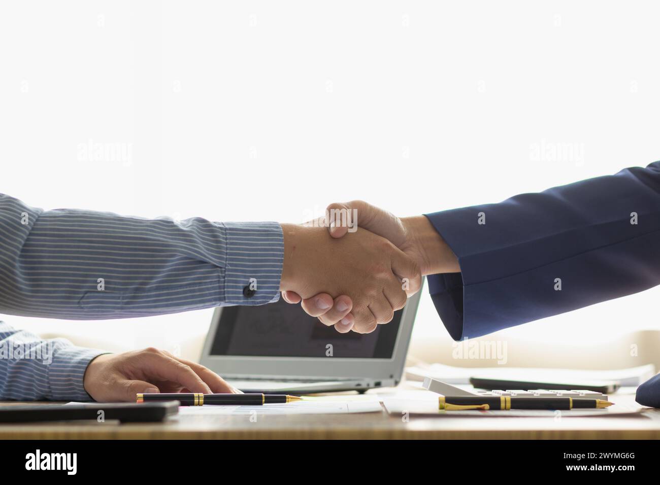 Businessmen and investors shake hands as symbol of joint venture after ...