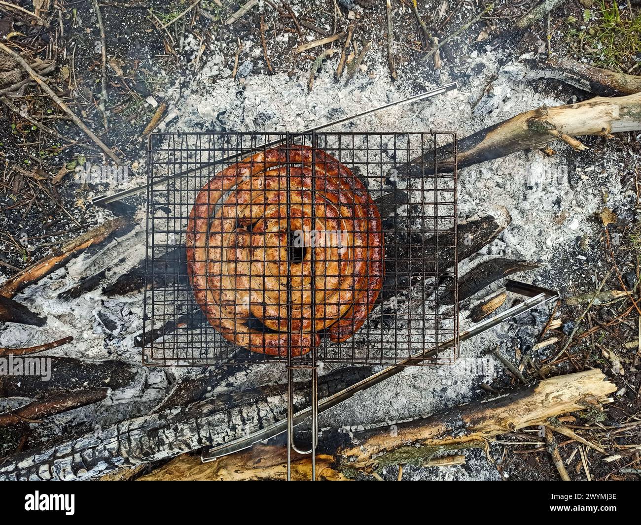 Homemade sausage grilled over a fire at a picnic Stock Photo - Alamy