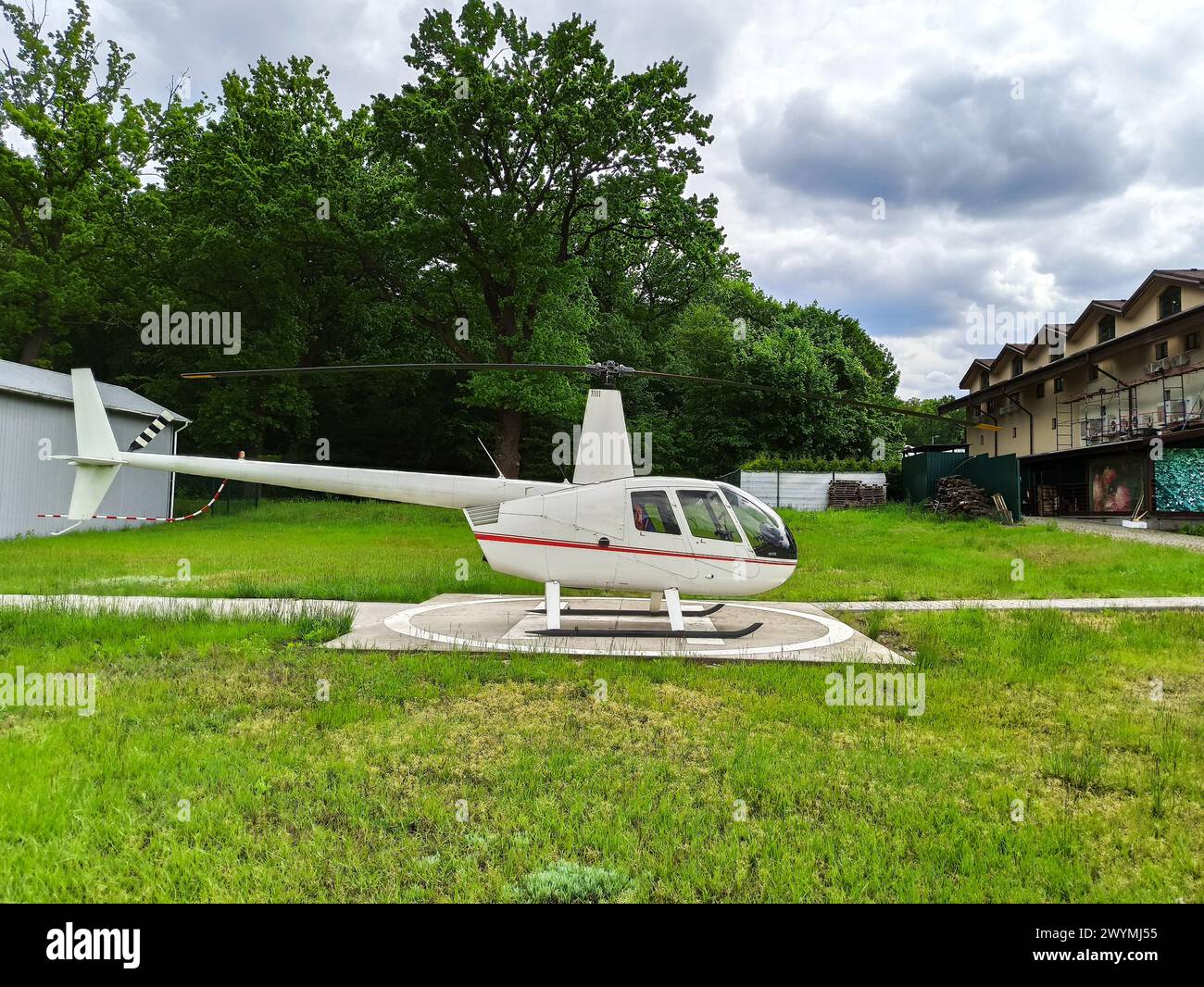White helicopter parked on a helipad Stock Photo - Alamy