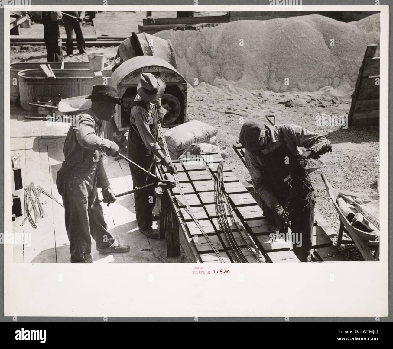 Pier plant. Placing perforated steel reinforcing strips in pier forms ...