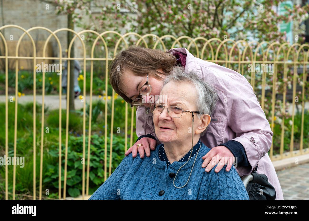 Happy daughter with Down Syndrome embracing her 85 yo mother in a ...
