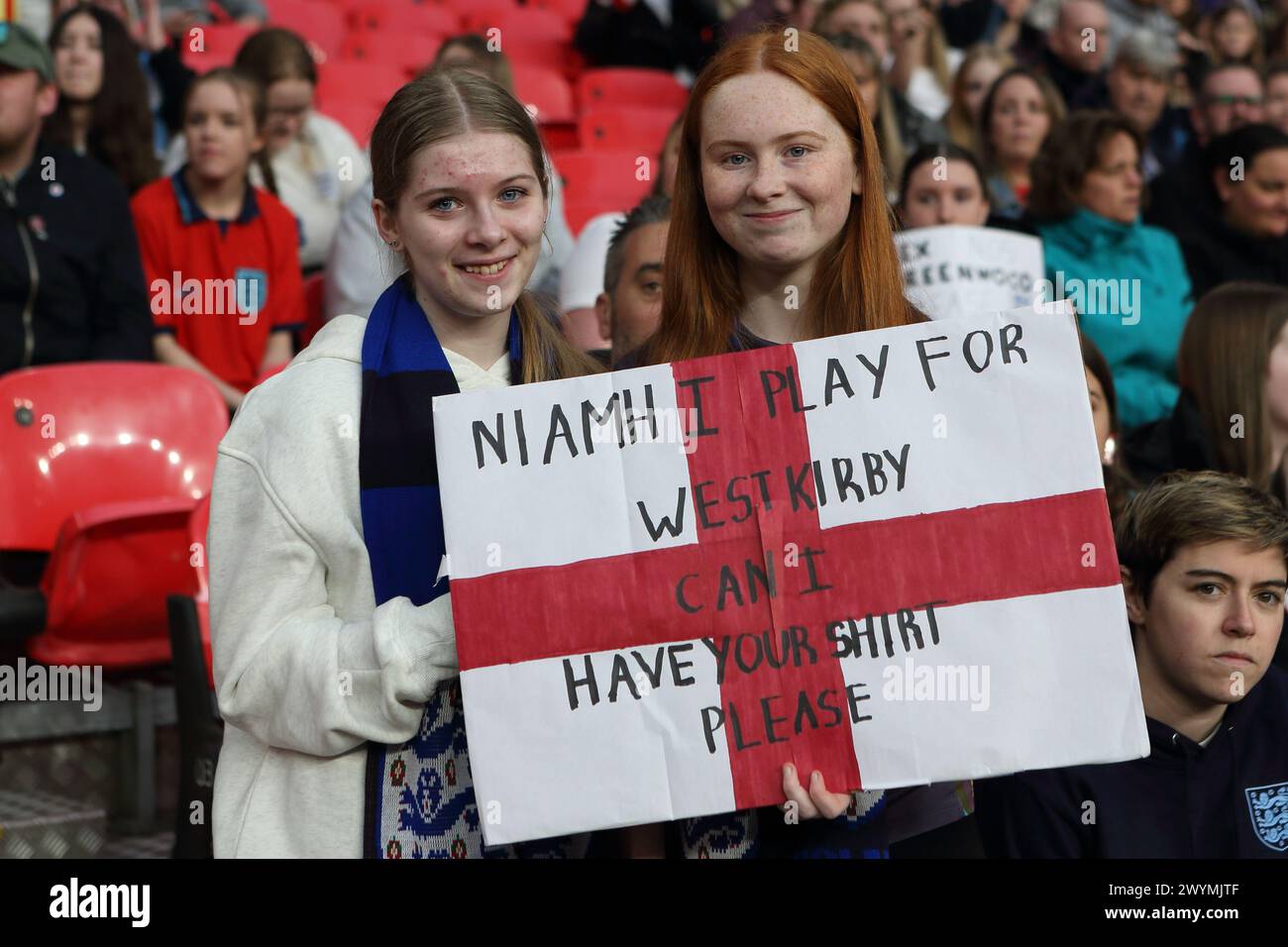 Teenage fans with homemade placard Niamh Charles West Kirby England v ...