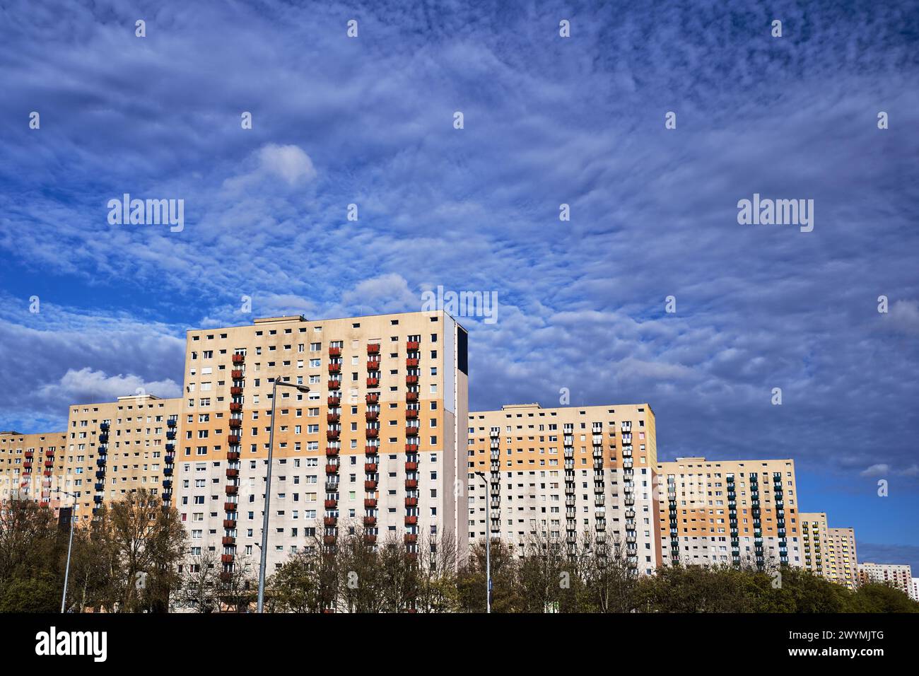 The facade with balconies of a residential high-rise building in Poznan ...