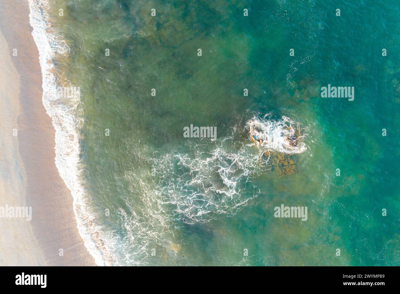 drone aerial view of a beach shore with a rock in the sea Stock Photo ...