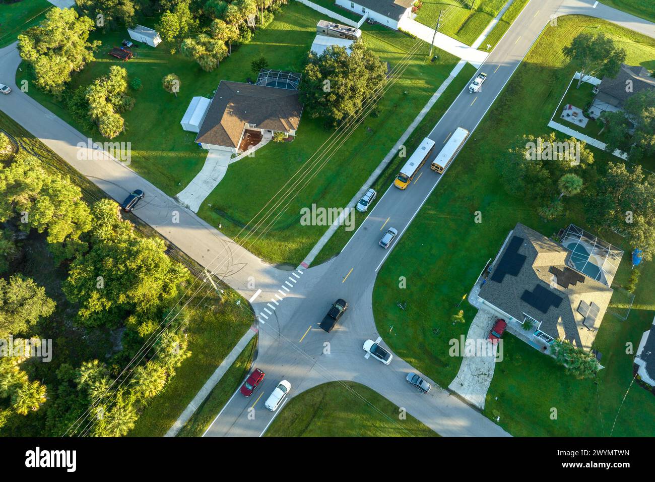 Aerial view of american yellow school bus picking up children at ...
