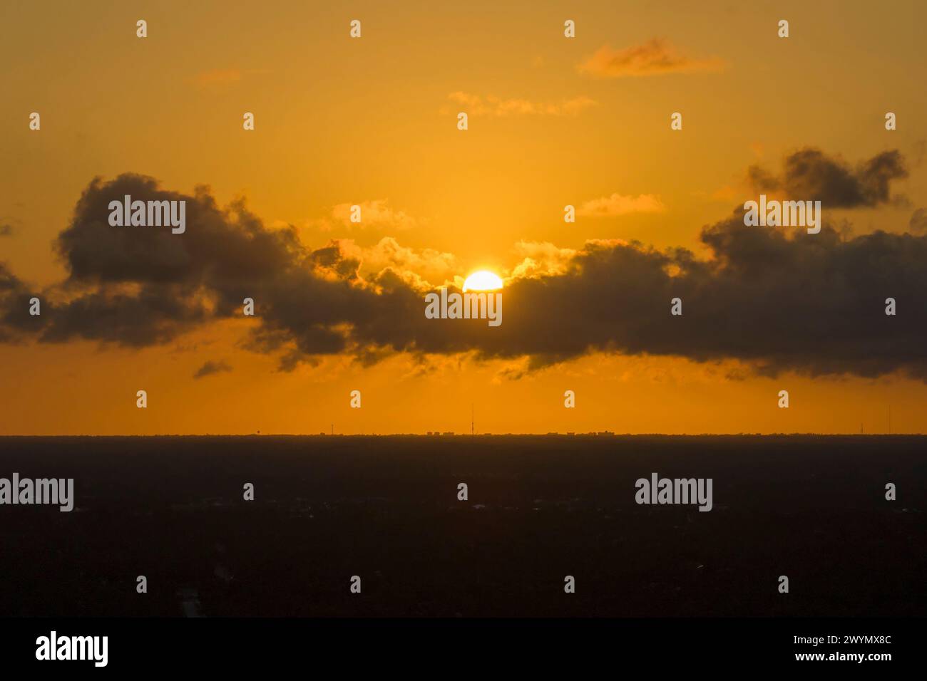 Golden sun setting behind dark hi-res stock photography and images - Alamy