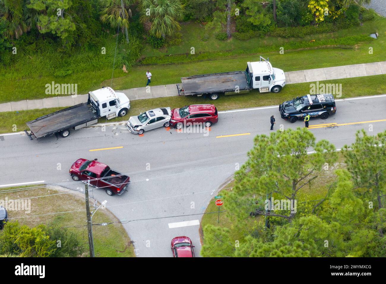 Car crash site with emergency services personnel and vehicles ...