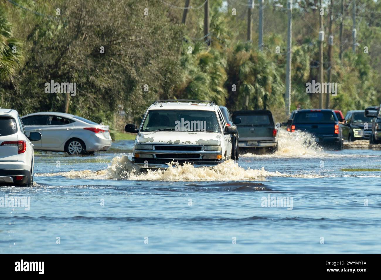 Flooded street after hurricane rainfall with driving cars in Florida ...