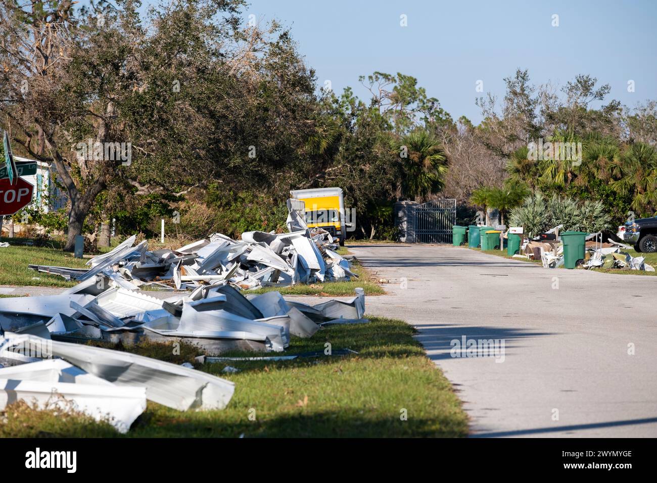 Heaps of debris rubbish on street side near severely damaged by ...