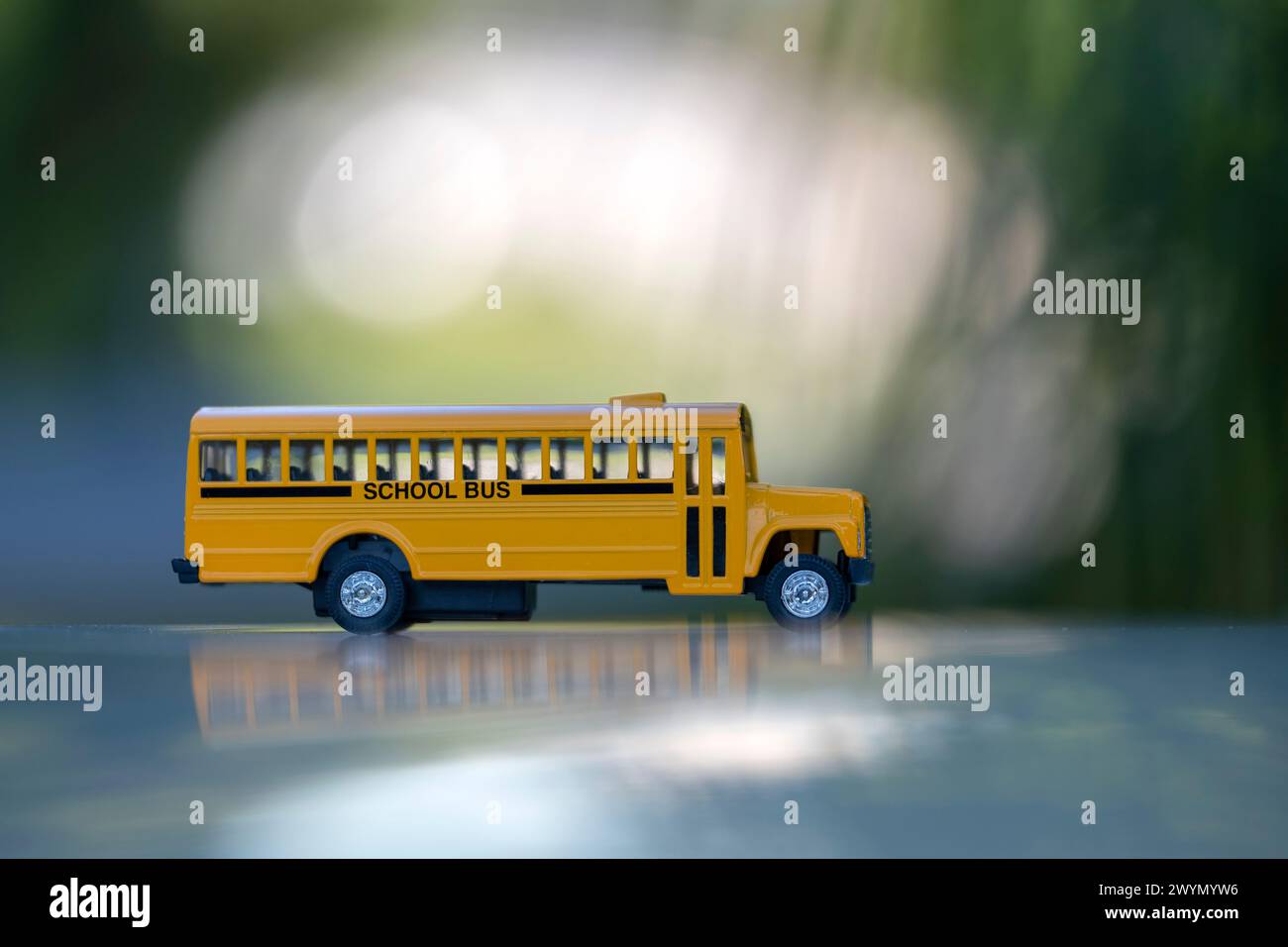 Little model of american yellow school bus outdoor. Concept of ...