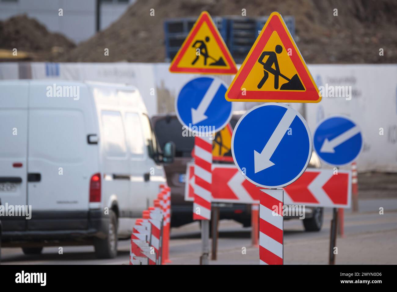 Roadworks warning traffic signs of construction work on city street and ...