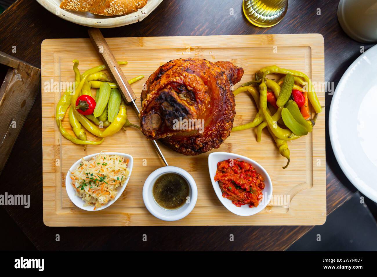 Roasted Ham Hock with pickled vegetables on wooden tray Stock Photo - Alamy