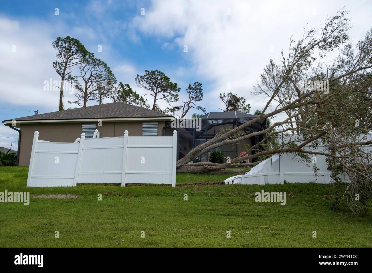 White plastic backyard fence damaged after hurricane winds in Florida ...
