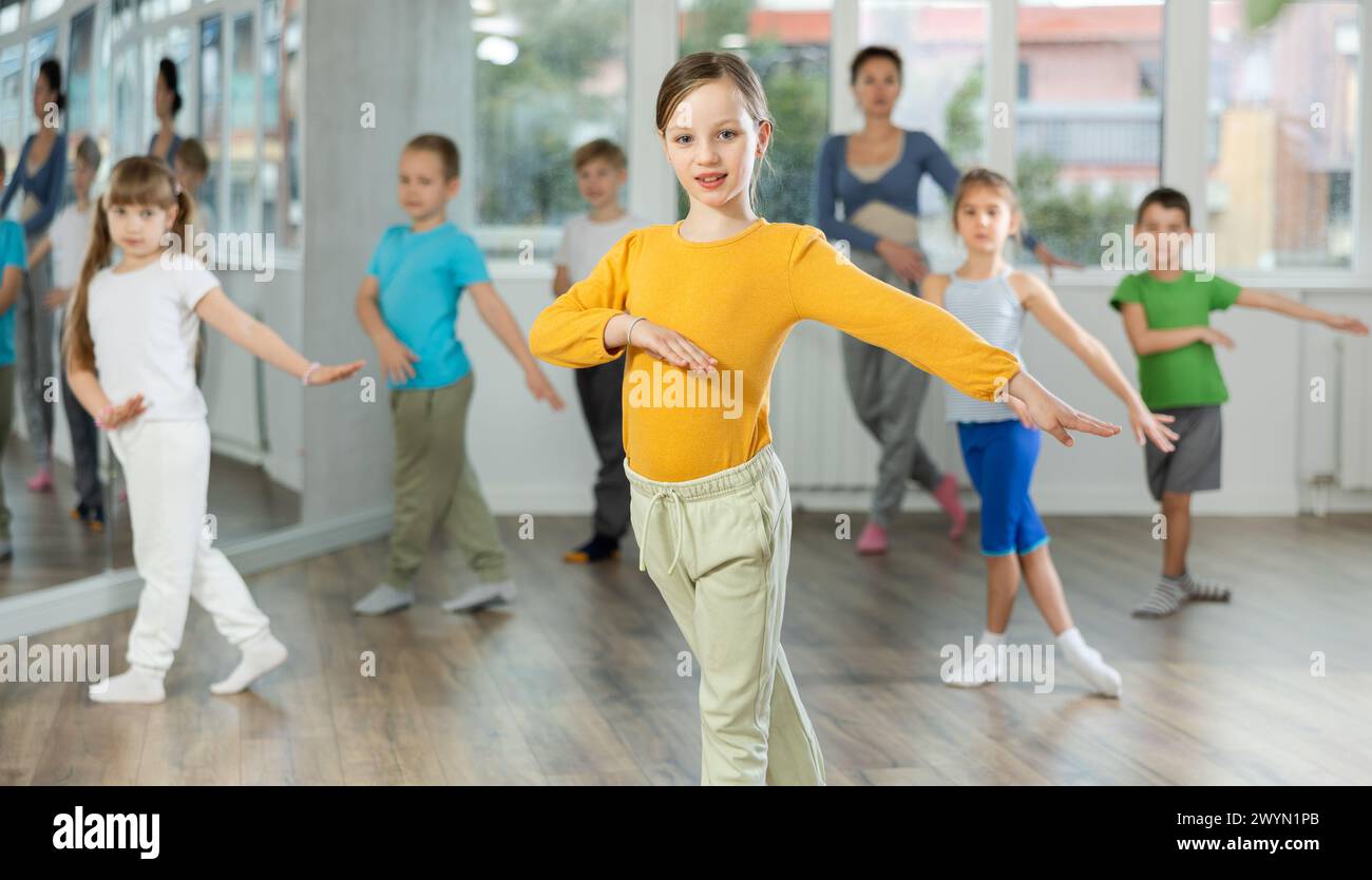 Girl learn to dance hip hop dances, doing movement with unrecognizable ...