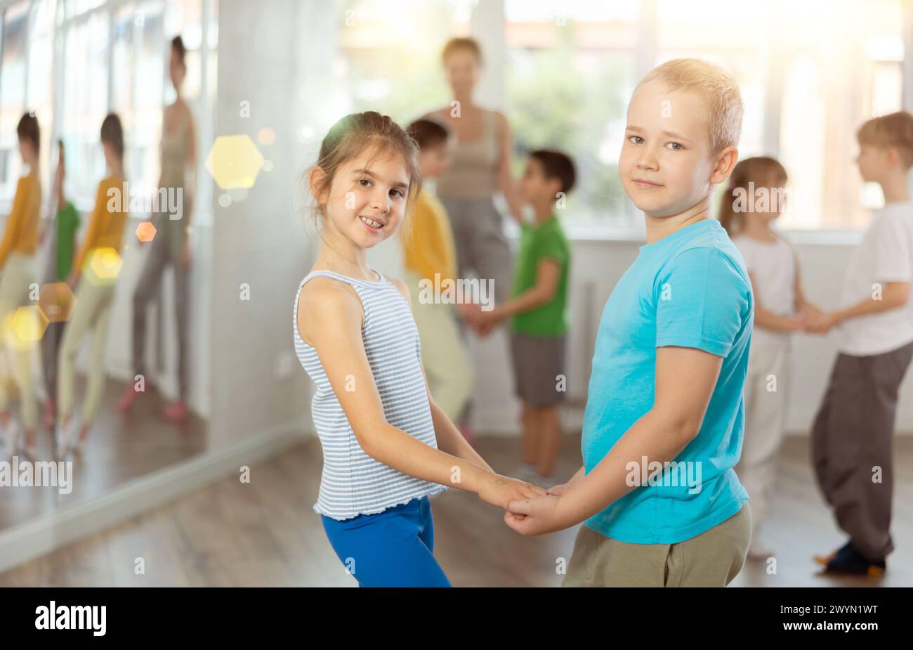 Happy preteen children practicing ballroom dances in pairs in training ...