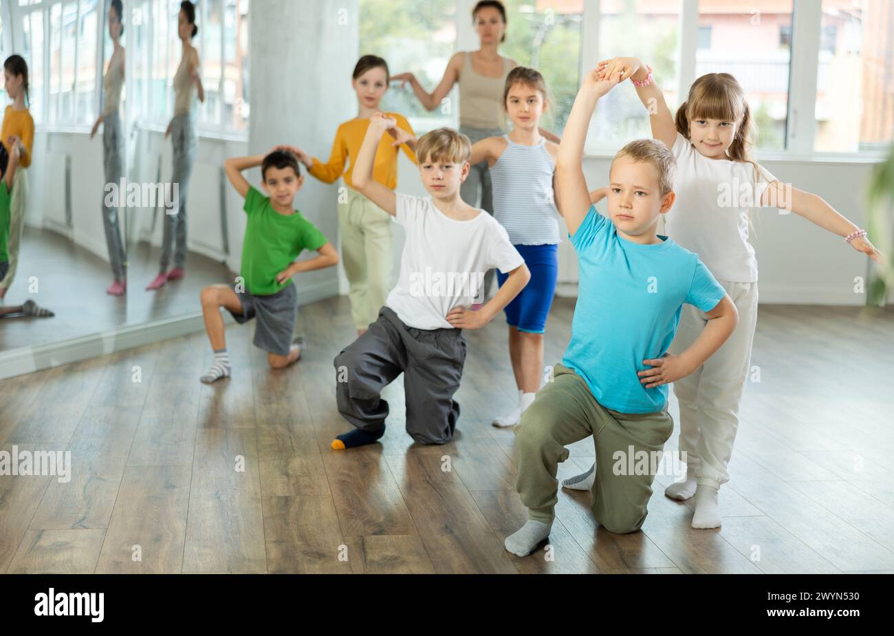 Preteen children learning to dance waltz in pairs in choreography class ...