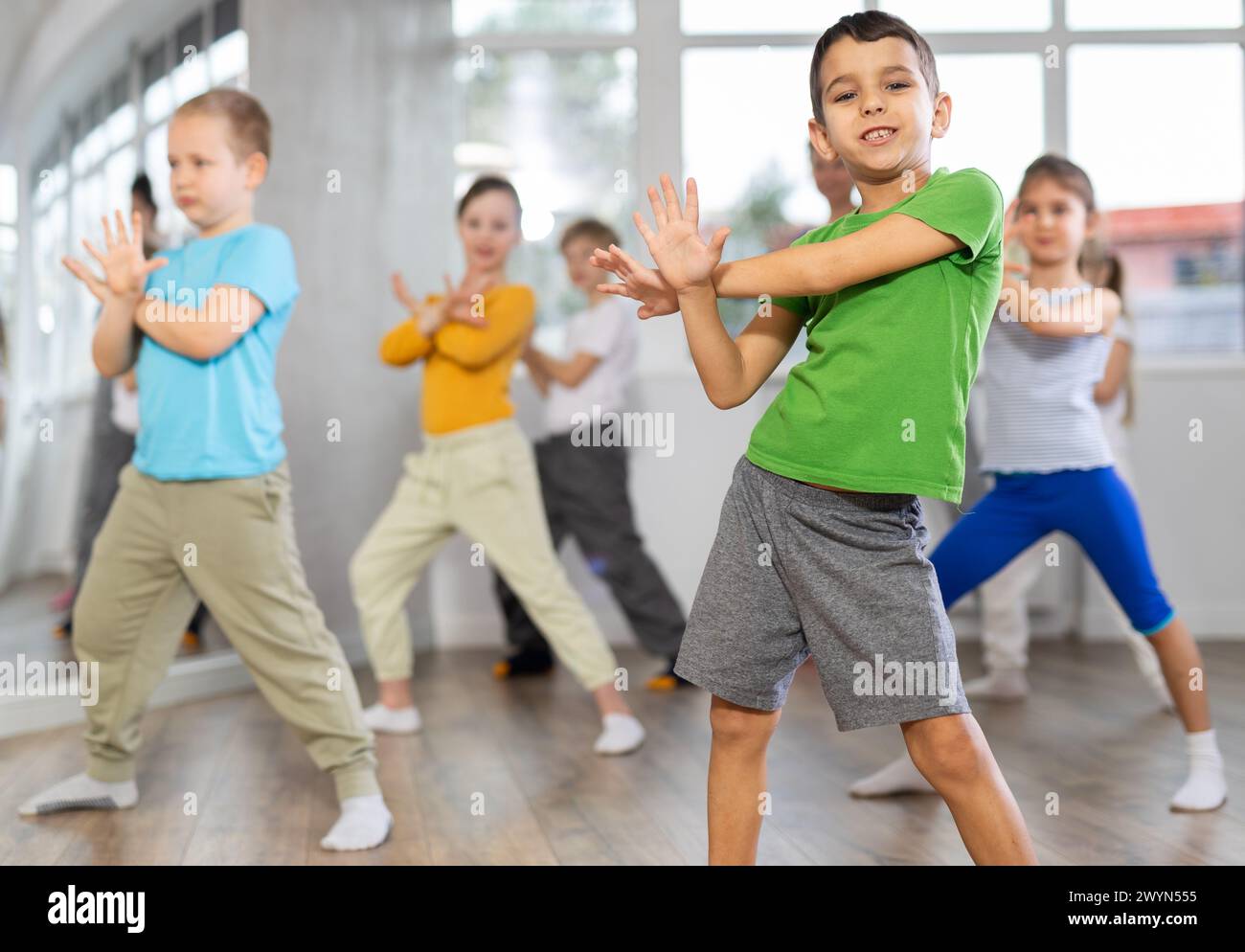 Happy smiling preteen boys and girls practicing dance, with female ...