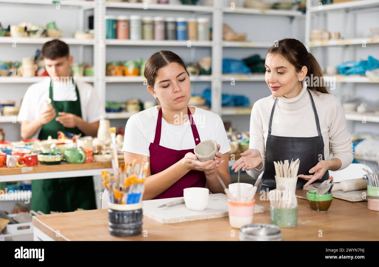 Joyous young women sculpting handmade cups Stock Photo - Alamy