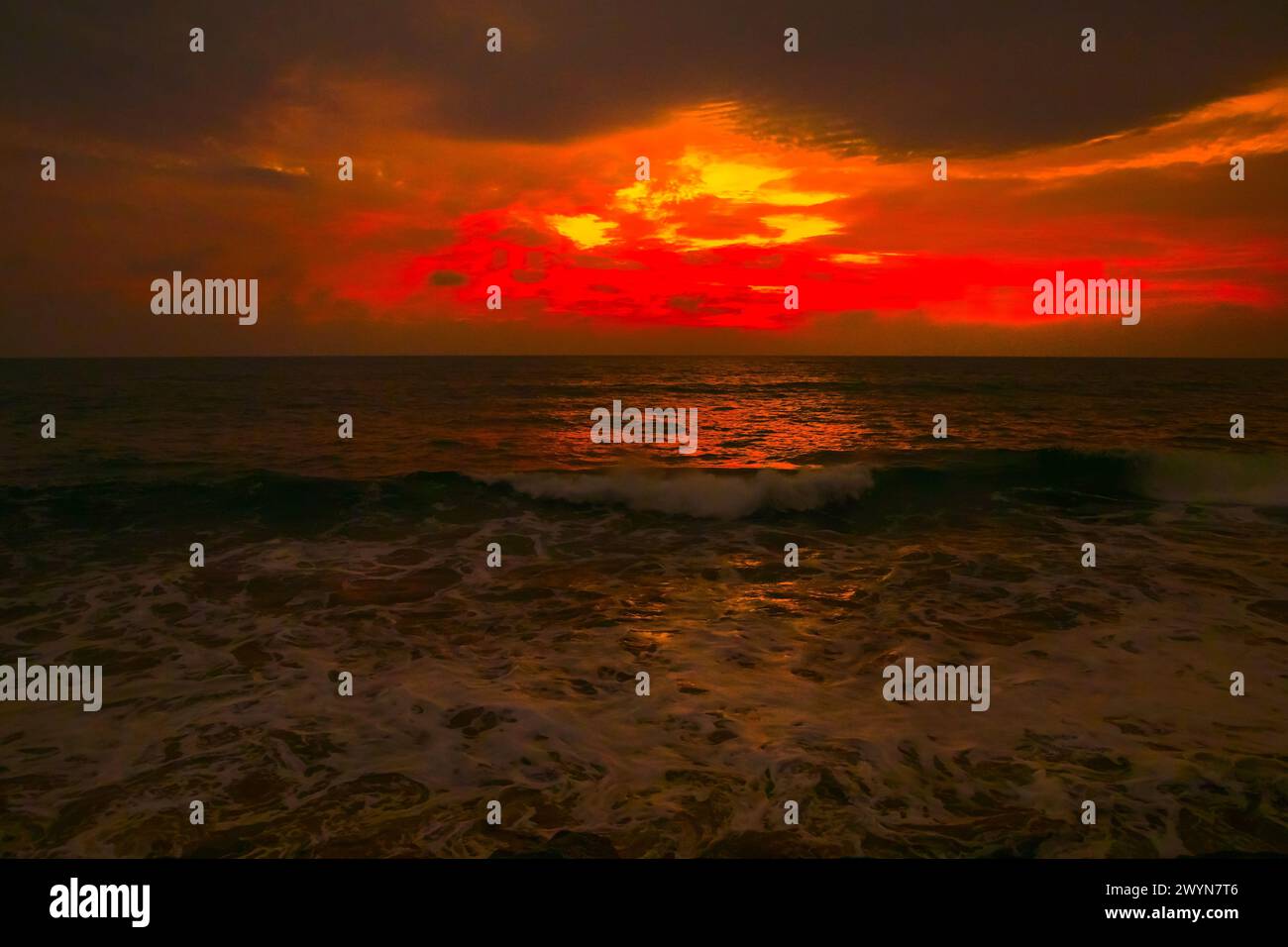 stunningly beautiful bright red dramatic sunset sky over indian ocean ...