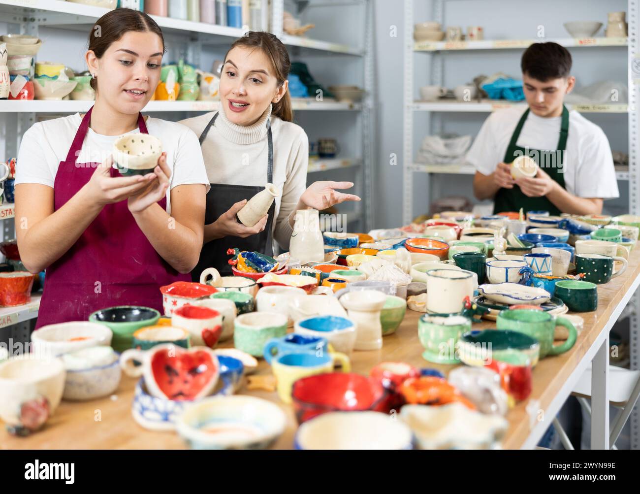 Female potter examining earthenware hi-res stock photography and images ...