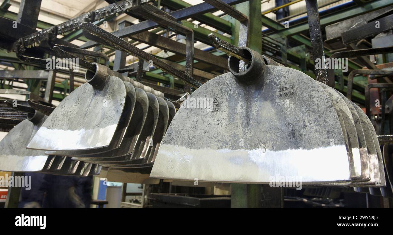 Hoes on holders ready to be painted, hand tool manufacturing ...