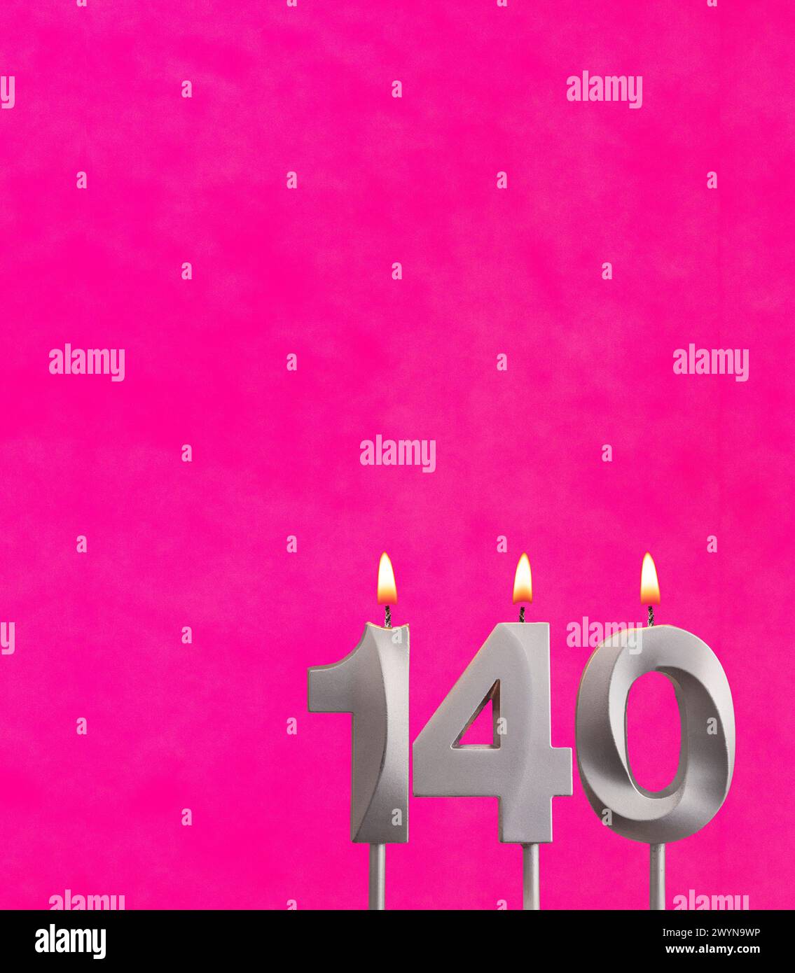 Candle 140 with flame - Birthday card in fuchsia background Stock Photo - Alamy