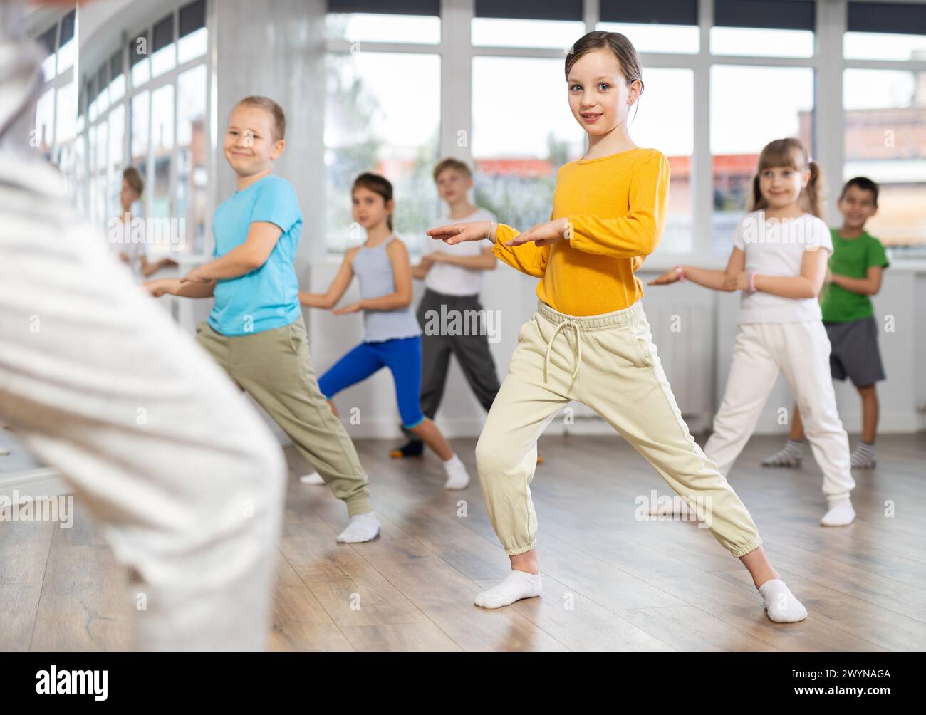 Happy smiling preteen boys and girls practicing dance, with female ...