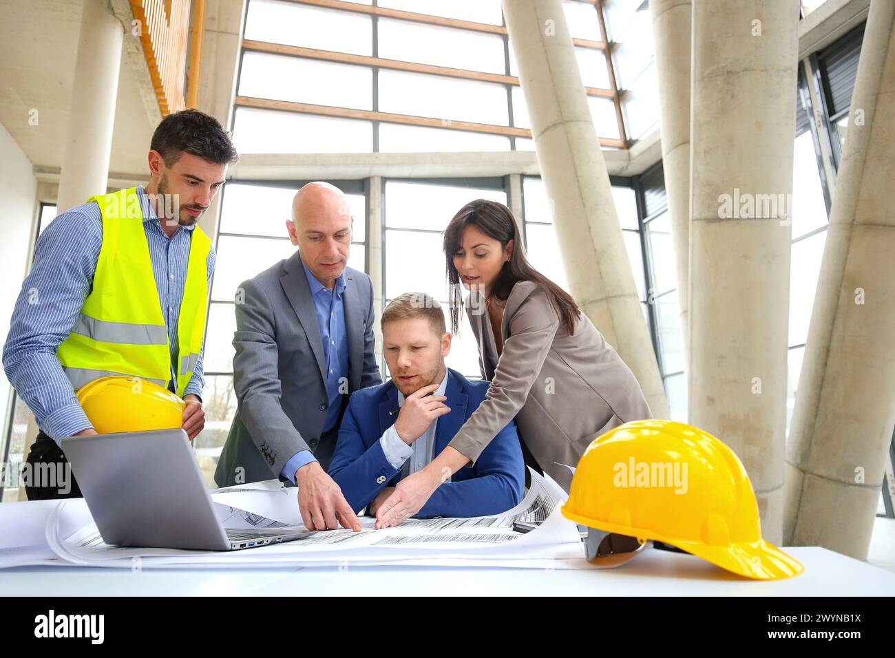 Architects looking at blueprints Stock Photo - Alamy