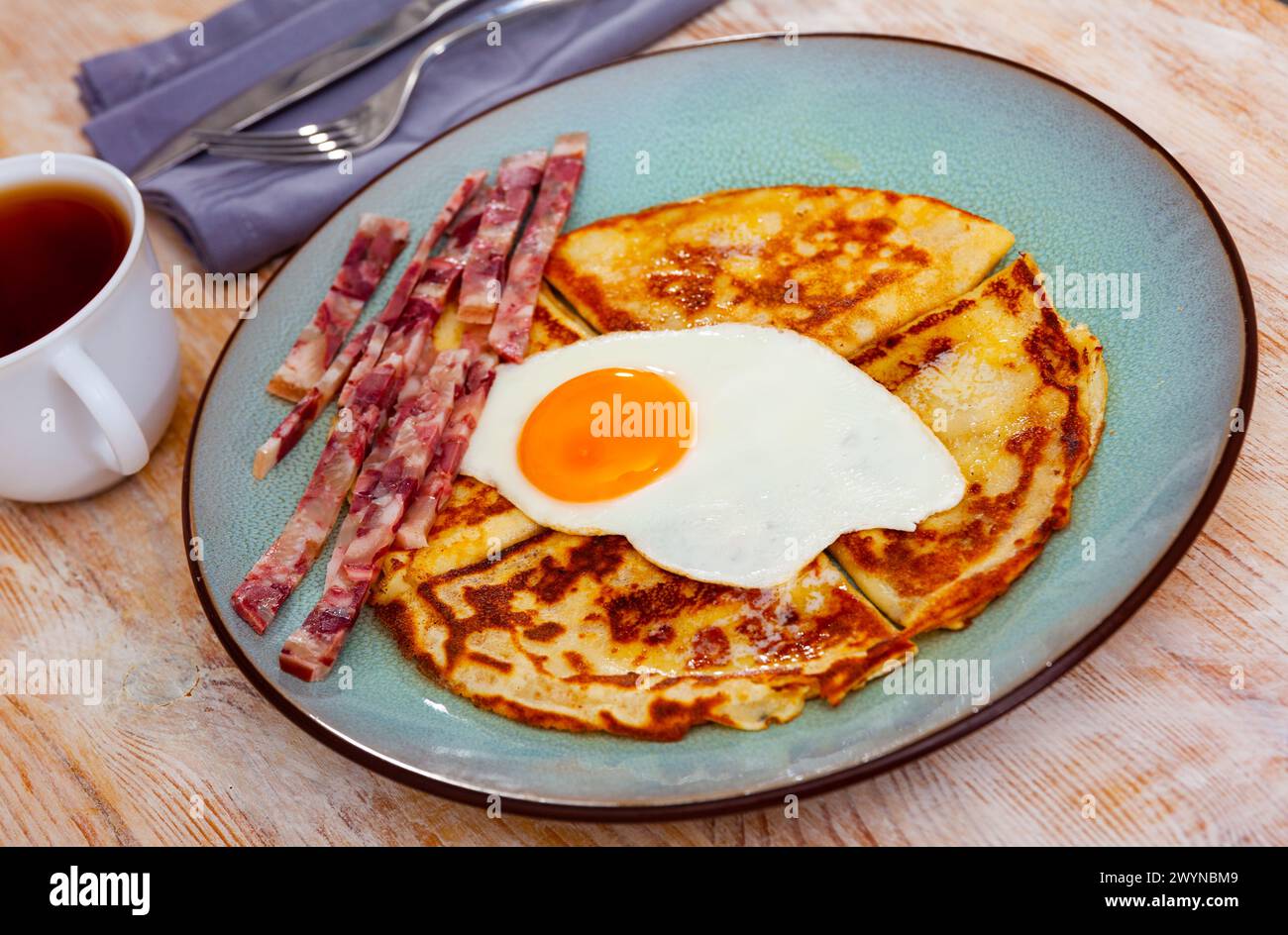Delicious pancakes with scrambled eggs and bacon Stock Photo - Alamy