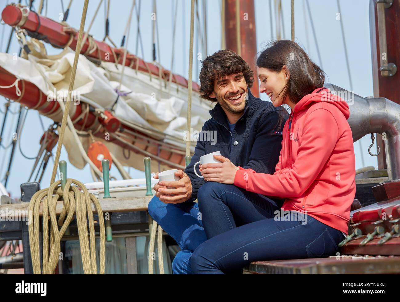 Couple outside a sailboat, galleon. Masts. Basque Country. Spain Stock ...