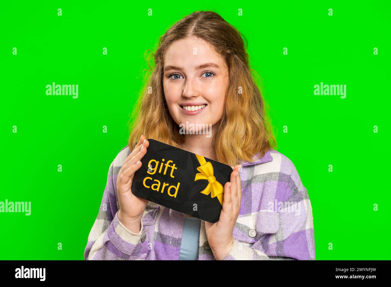Happy caucasian woman showing pointing on gift discount certificate ...