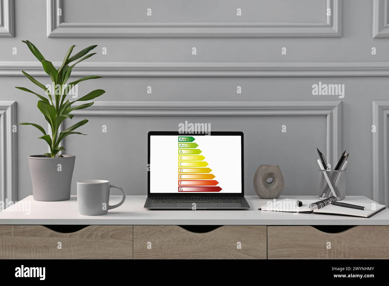 Energy efficiency rating on laptop display. Workplace with modern ...
