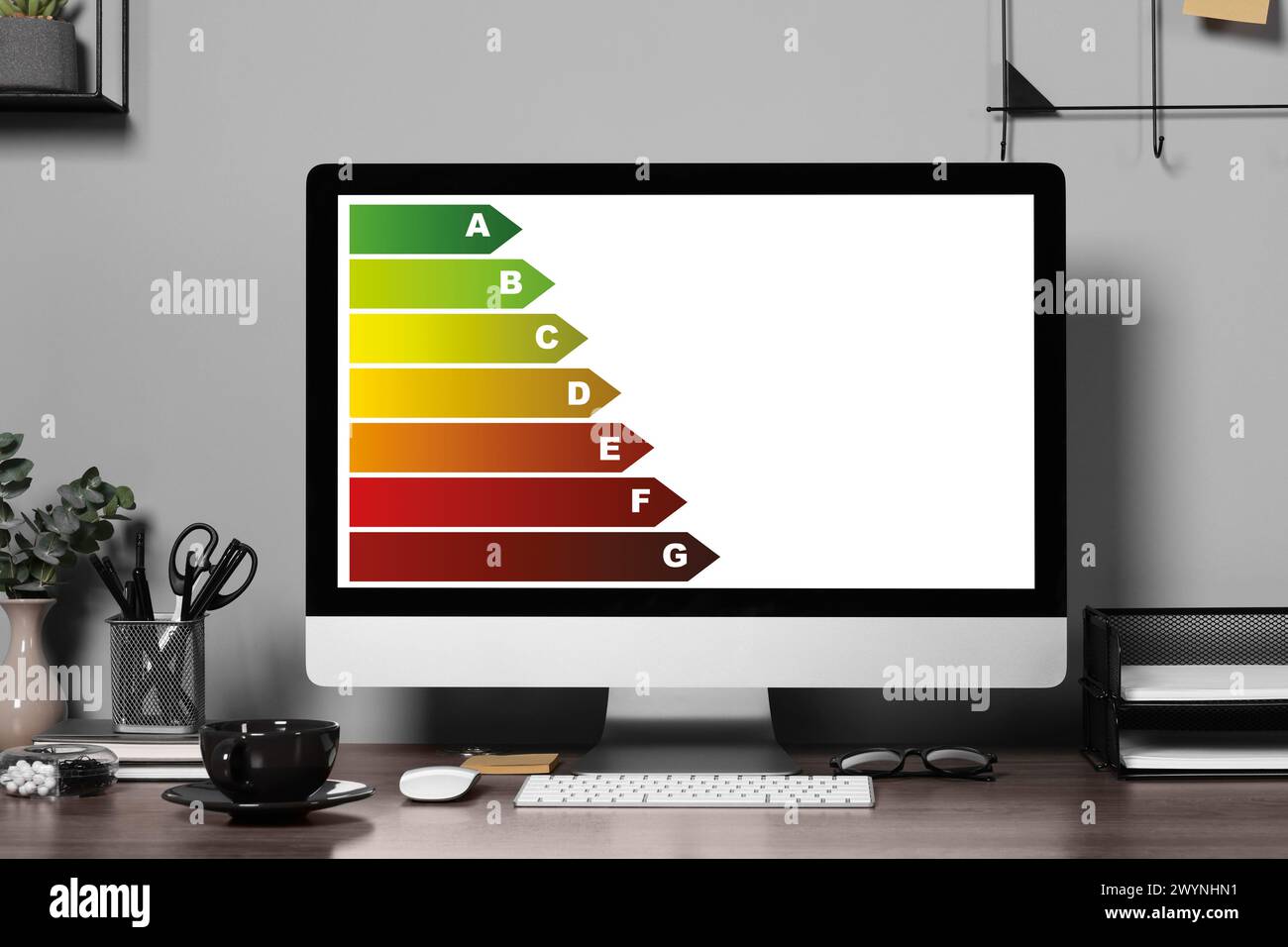 Energy efficiency rating on display. Workplace with modern computer ...